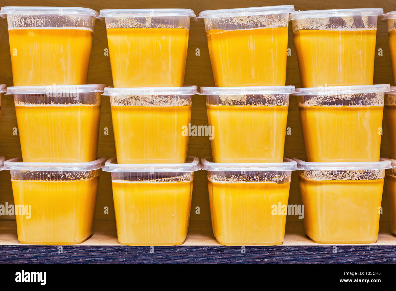 Honey in the transparent boxes on the shelf Stock Photo - Alamy