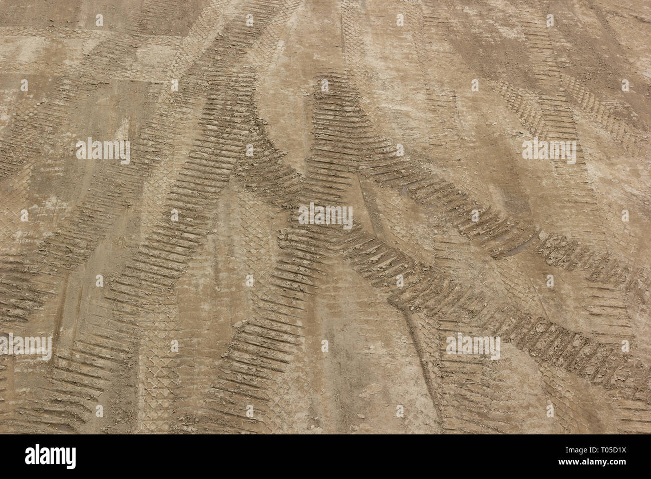 Tire tracks on a brown dirt road, textured imprints in different ...