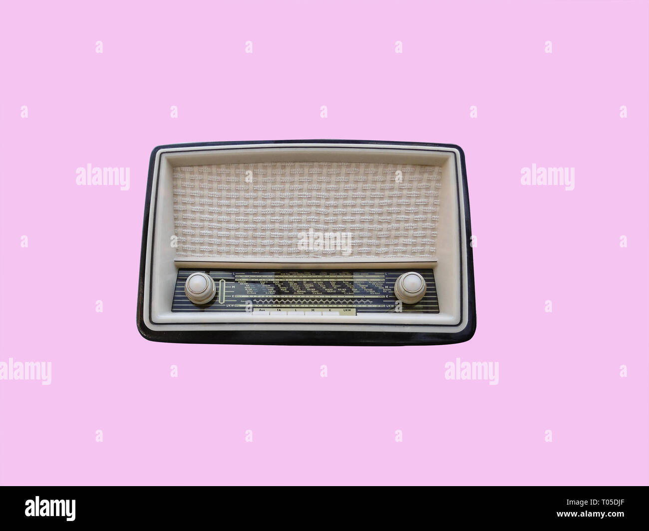 1950's retro vintage radio with turning knobs and speaker on a pastel ...