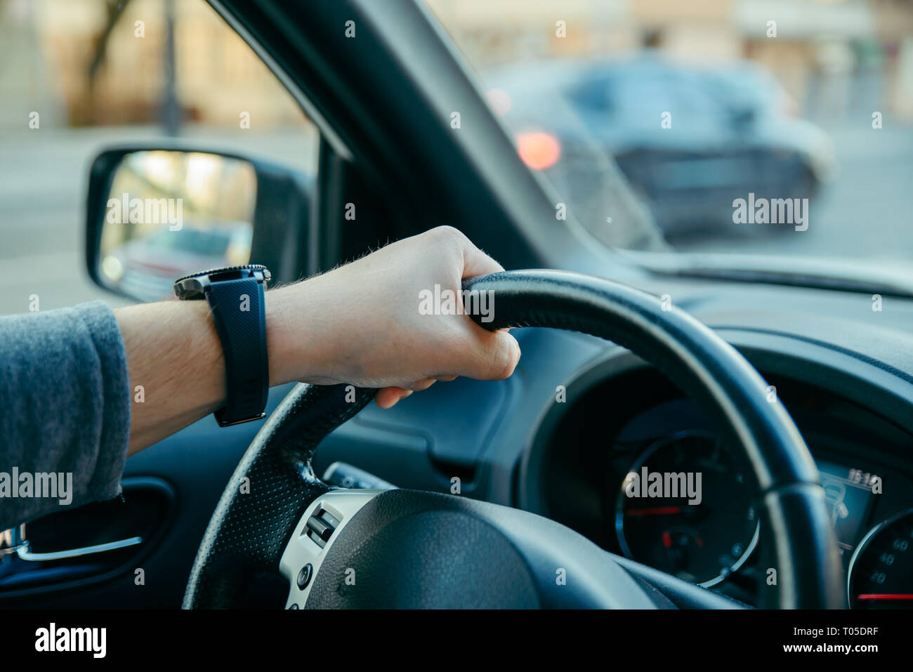 man driving car by city streets. view from inside Stock Photo - Alamy