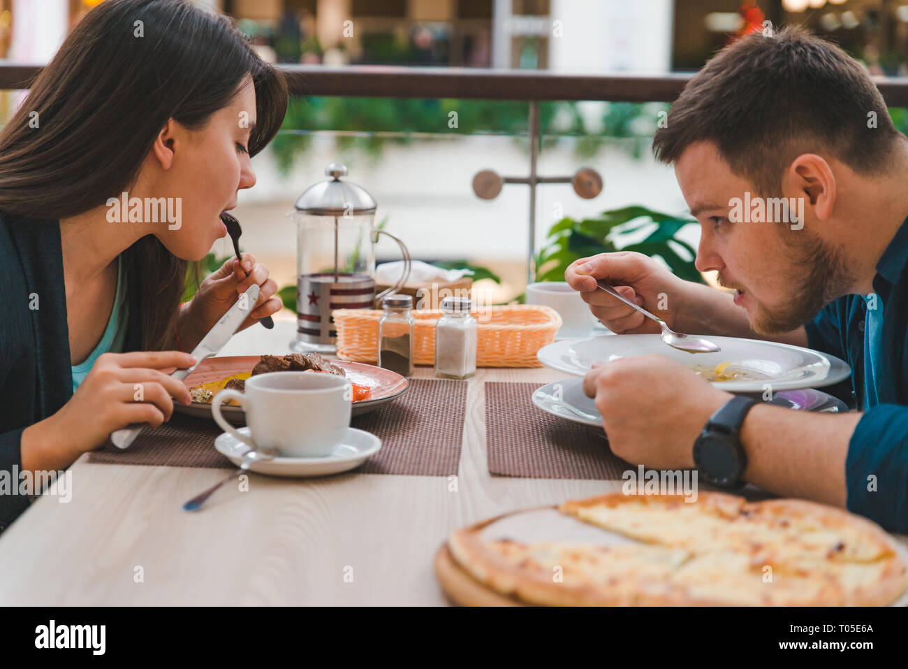 couple having lunch in mall cafe together. date talking. relationship ...