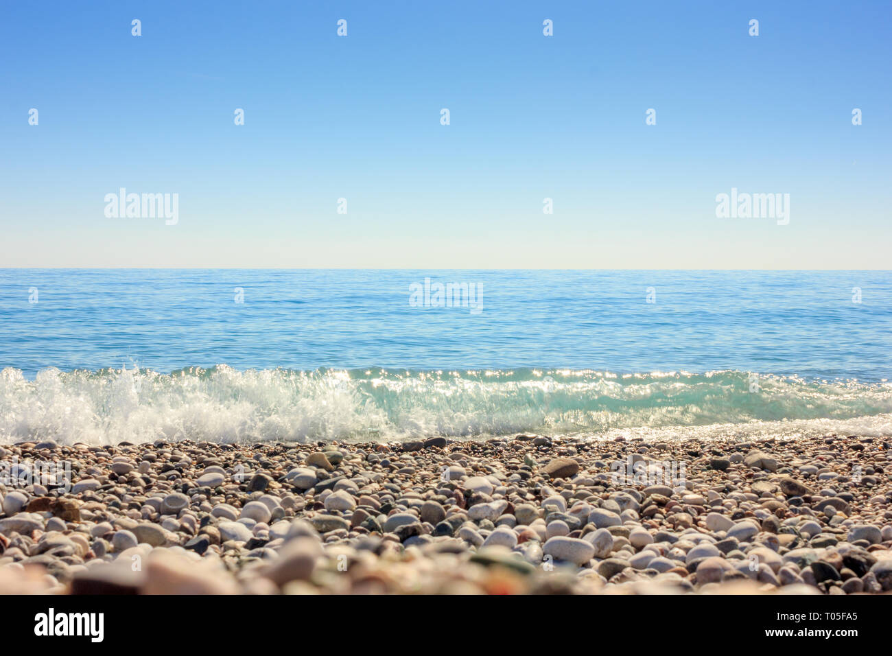 Mediterranean landscape in Antalya, Turkey. Blue sea, waves and pebble ...