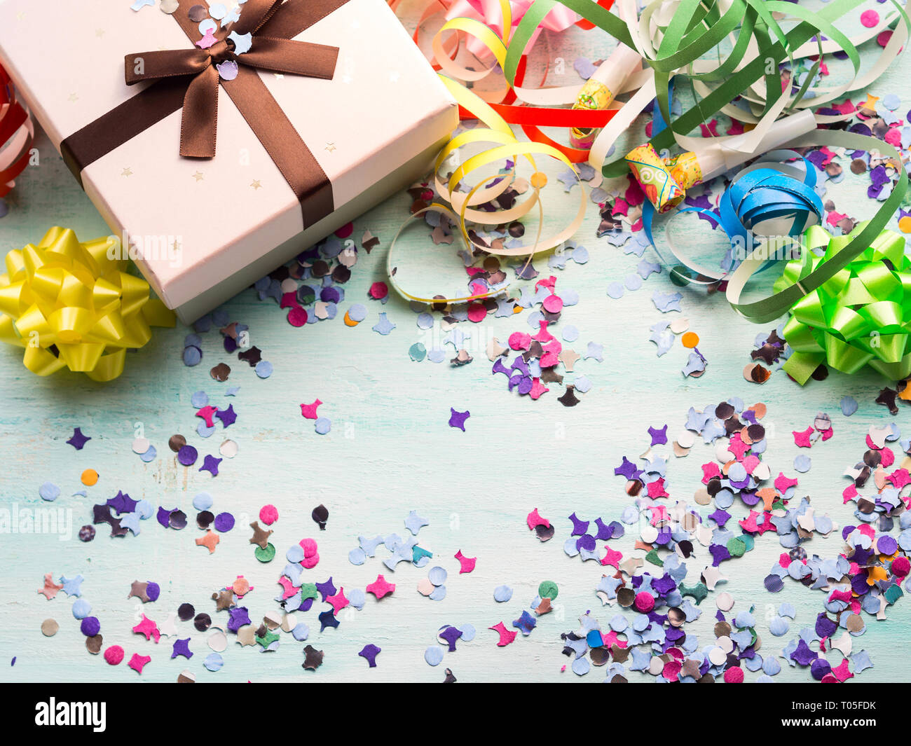 Open gift box with party streamers and confetti, bows. Bright colors ...