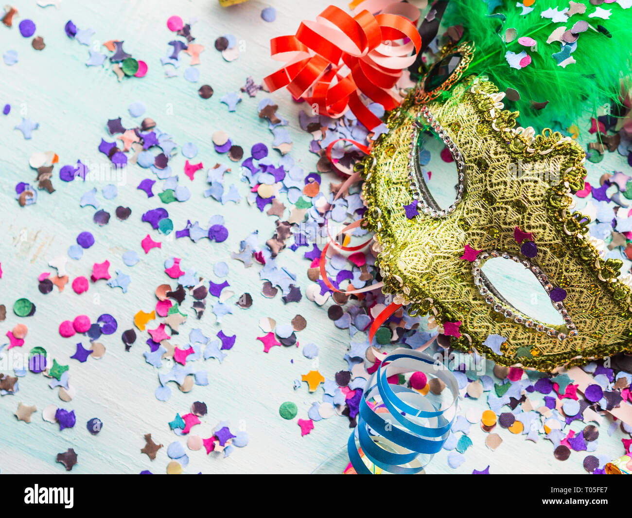 Masquerade carnival mask and confetti, streamers, bows on light ...