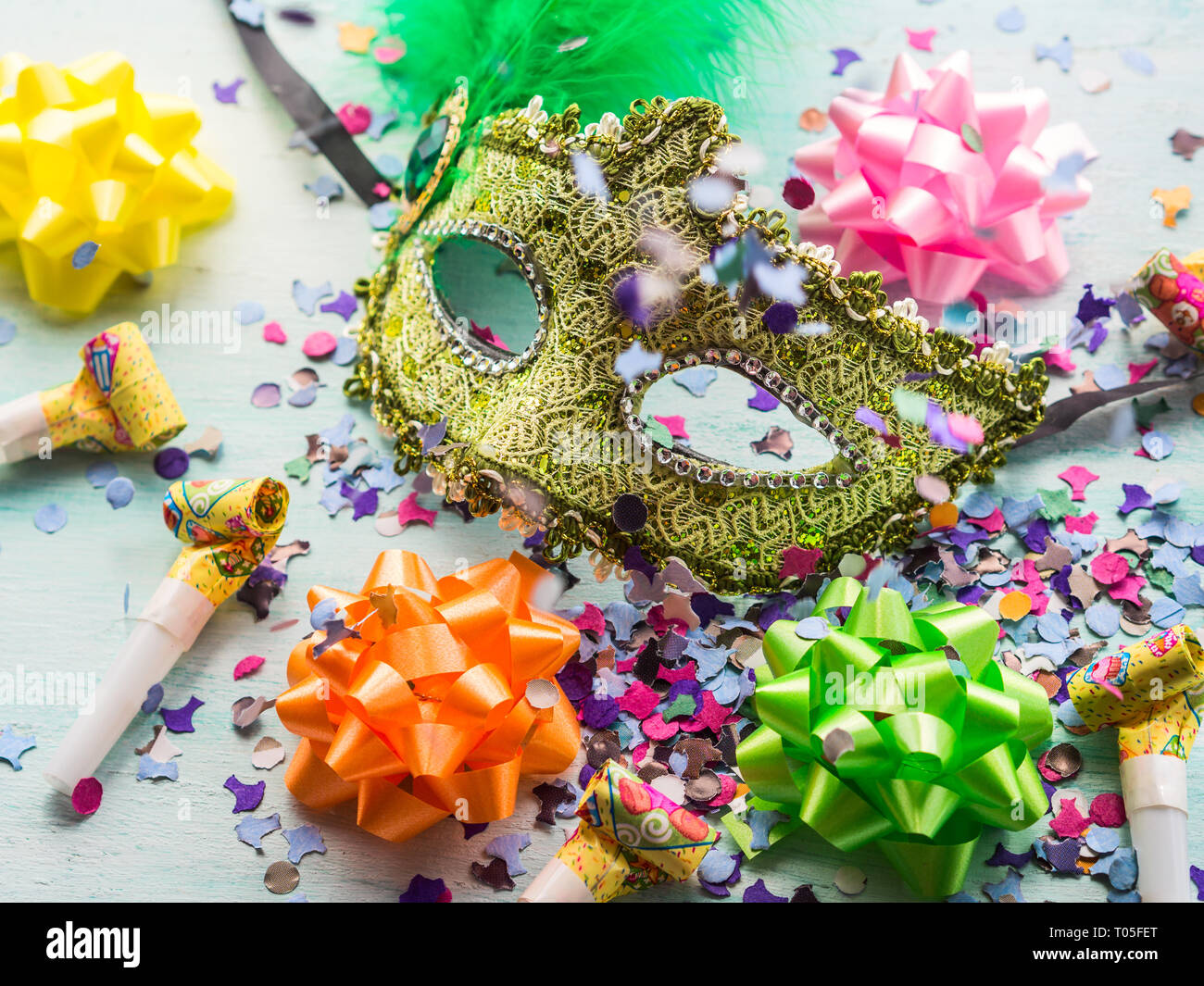 Masquerade carnival mask and confetti, streamers, bows on light ...