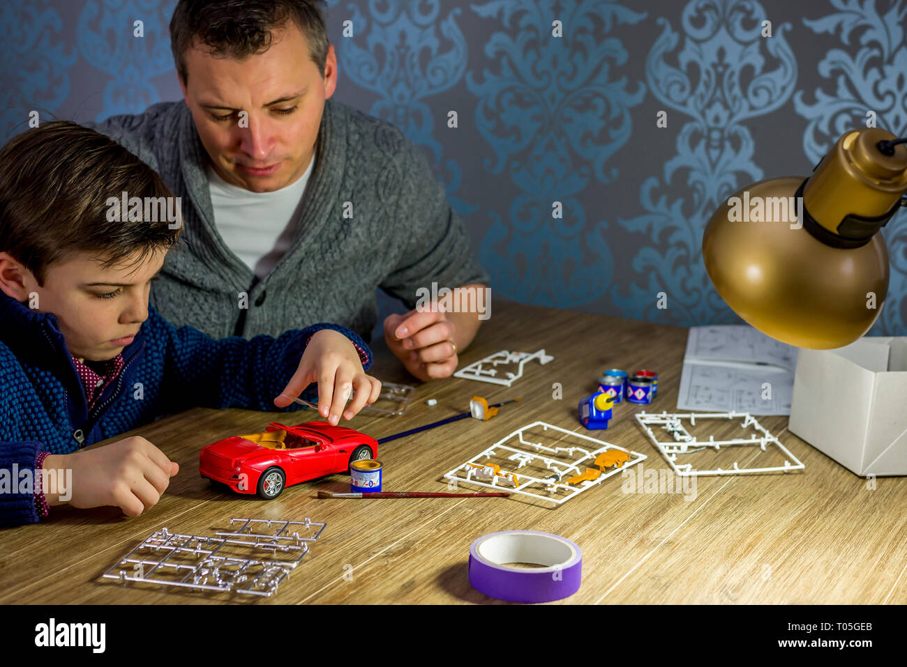 Son and father building a car kit hi-res stock photography and images ...
