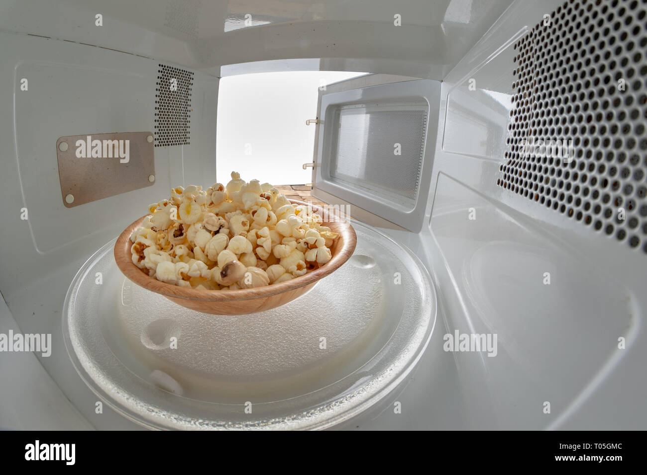 Microwave and bowl filled with popcorn. Device for heating dishes with ...