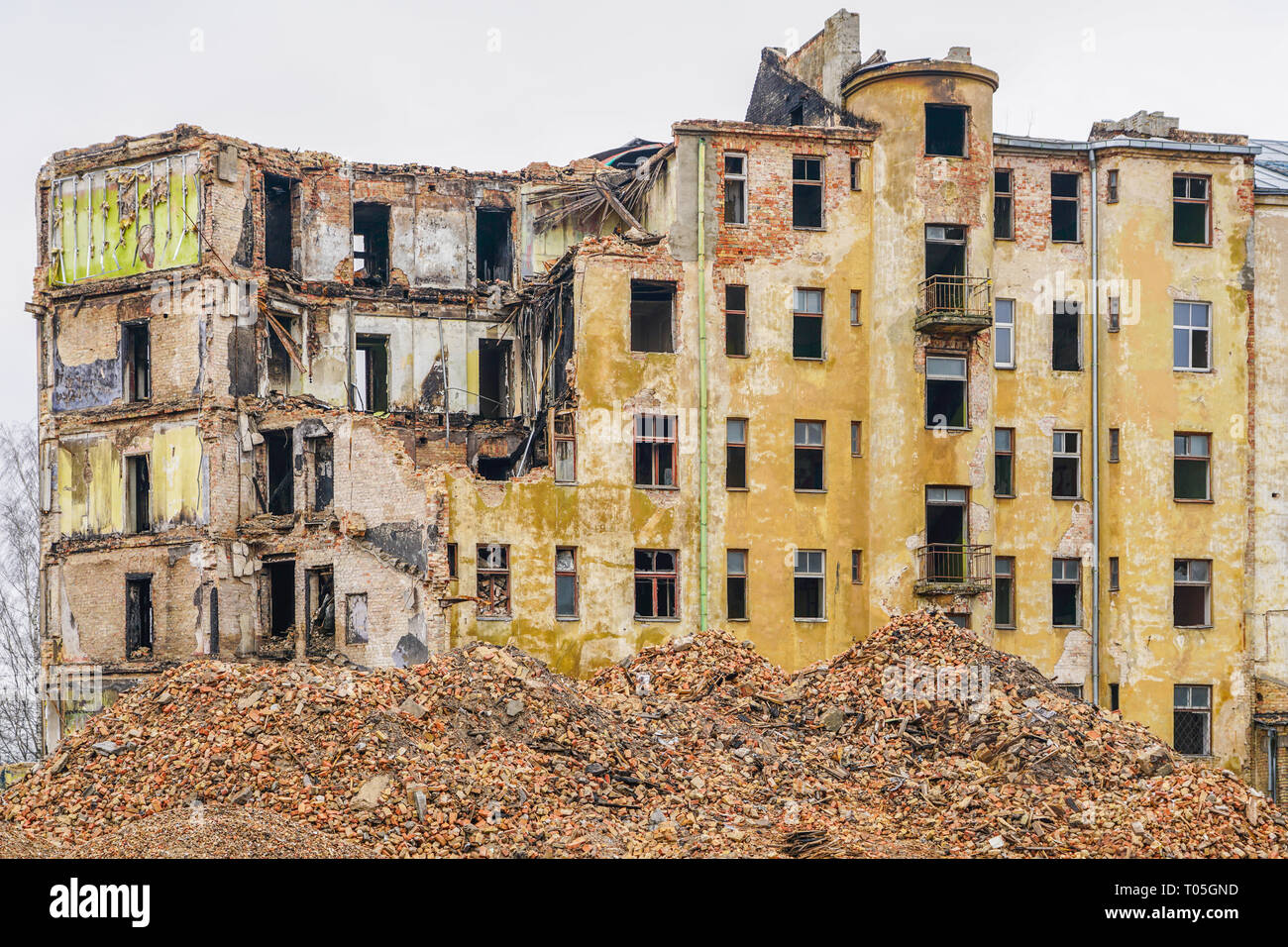 demolition of a large old historic stone house in the city, brick pile ...