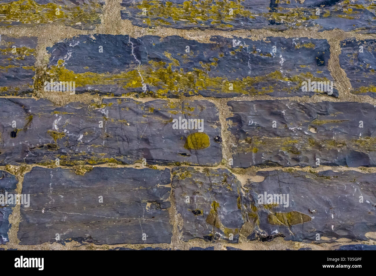 pattern of big grey rocks covered in moss, natural architecture ...