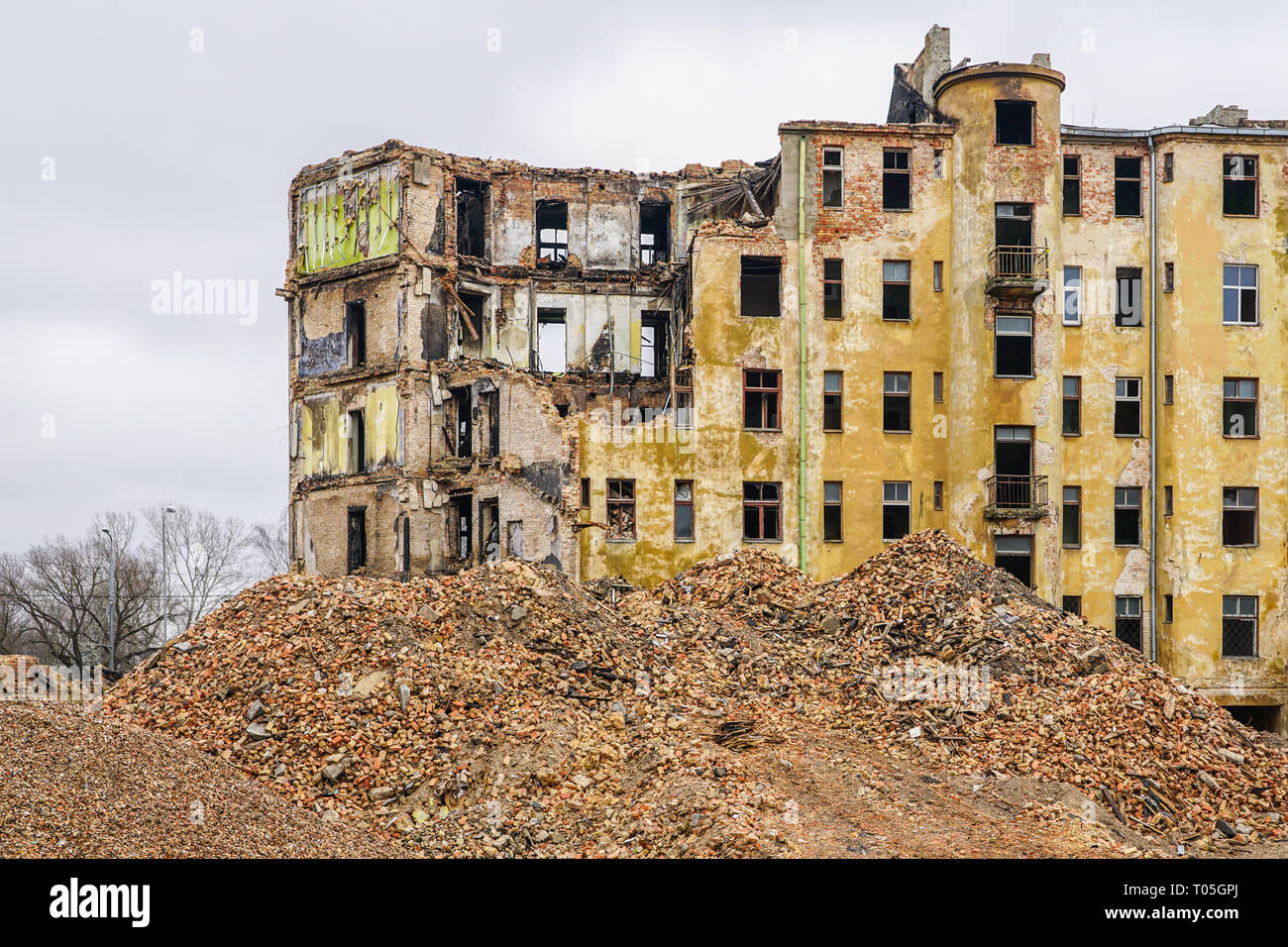 demolition of a large old historic stone house in the city, brick pile ...
