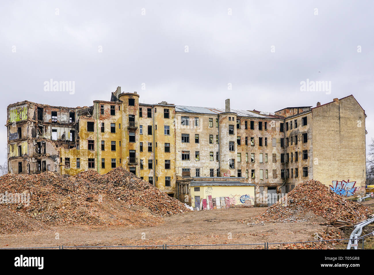 demolition of a large old historic stone house in the city, brick pile ...