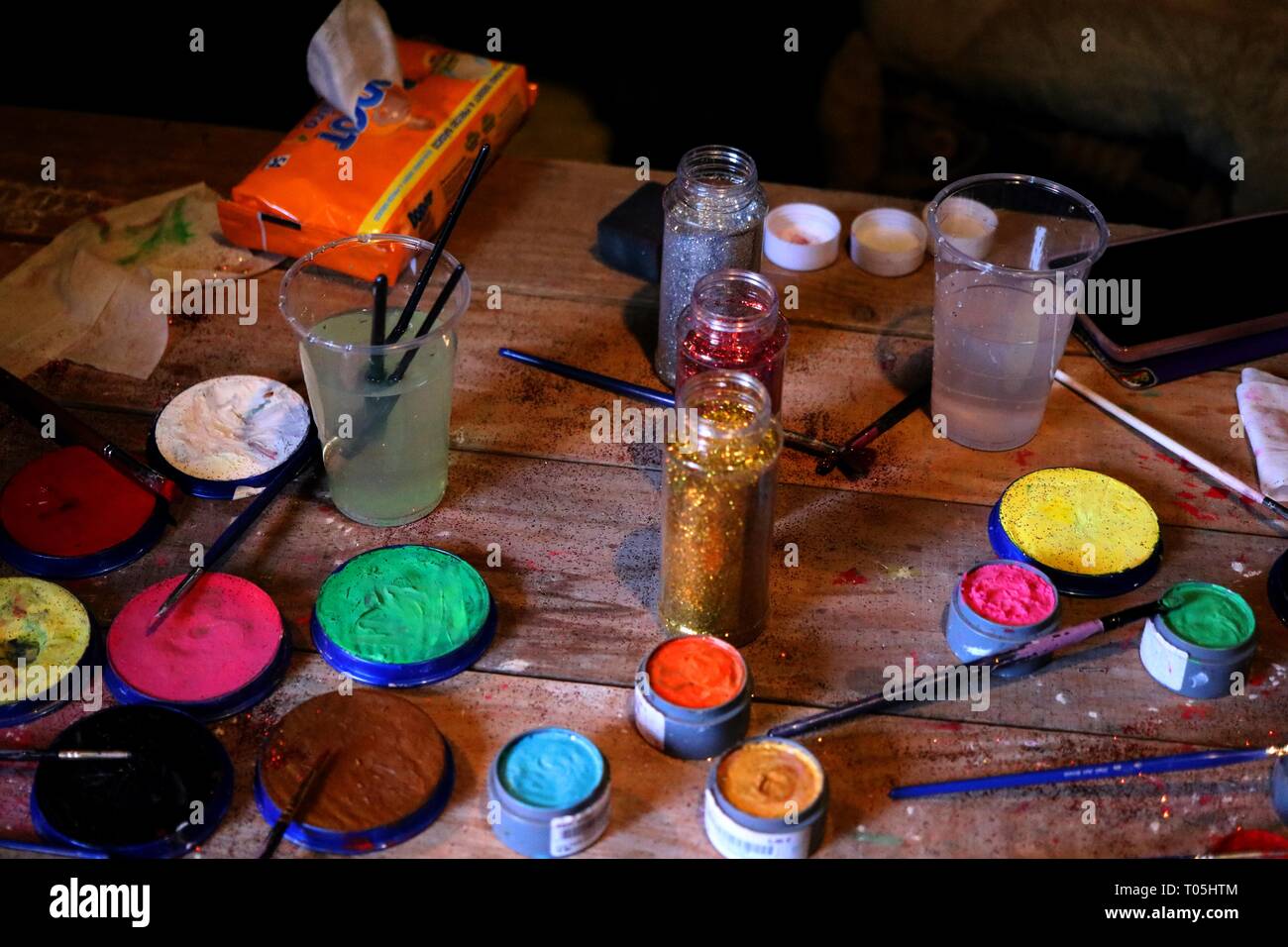 Table with multi colored paints Stock Photo - Alamy