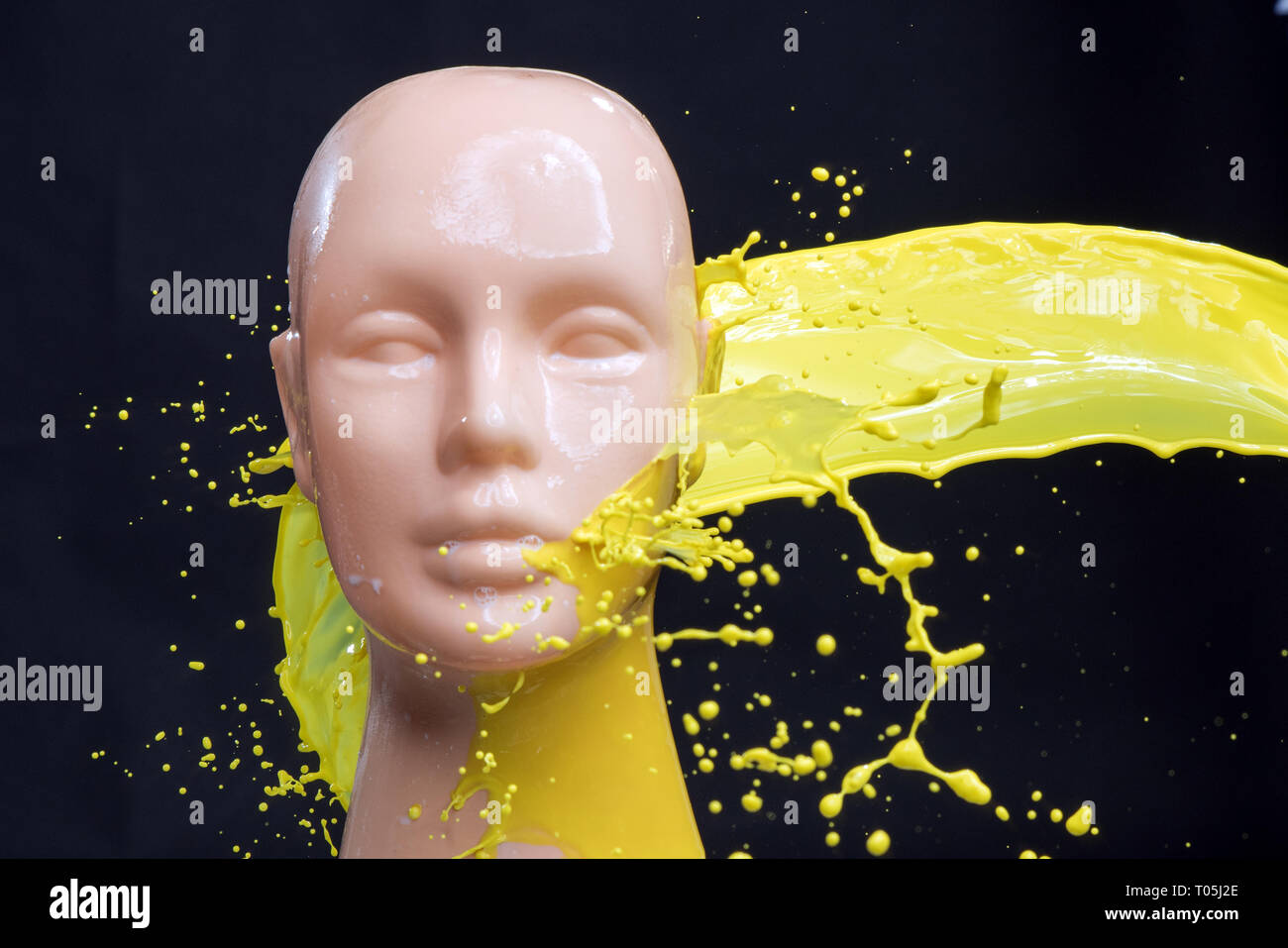 Mannequin splashed with bright yellow paint Stock Photo - Alamy