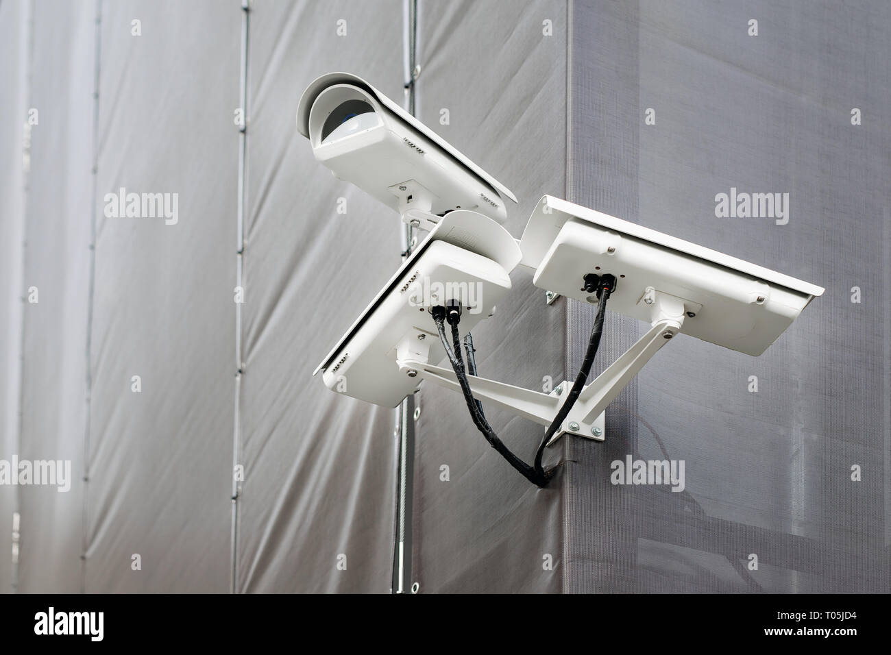 Three CCTV cameras on corner of building under restoration or renewal ...