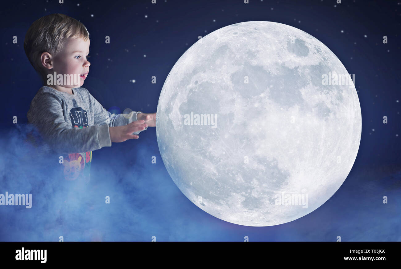 Art portrait of a cute, little boy holding a moon Stock Photo - Alamy