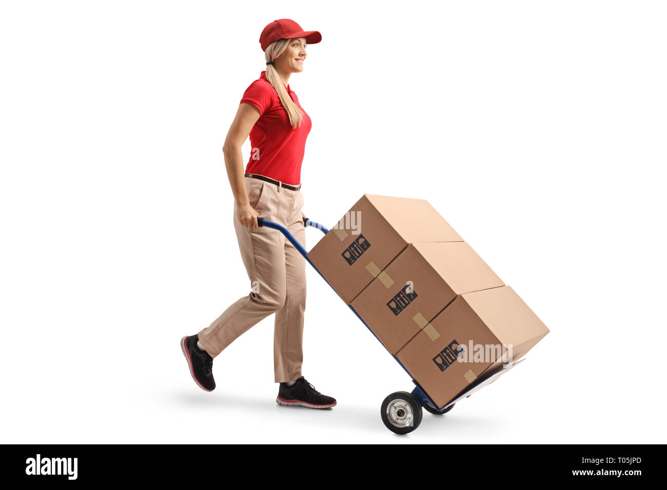 Full length shot of a female worker pushing boxes on a hand truck ...