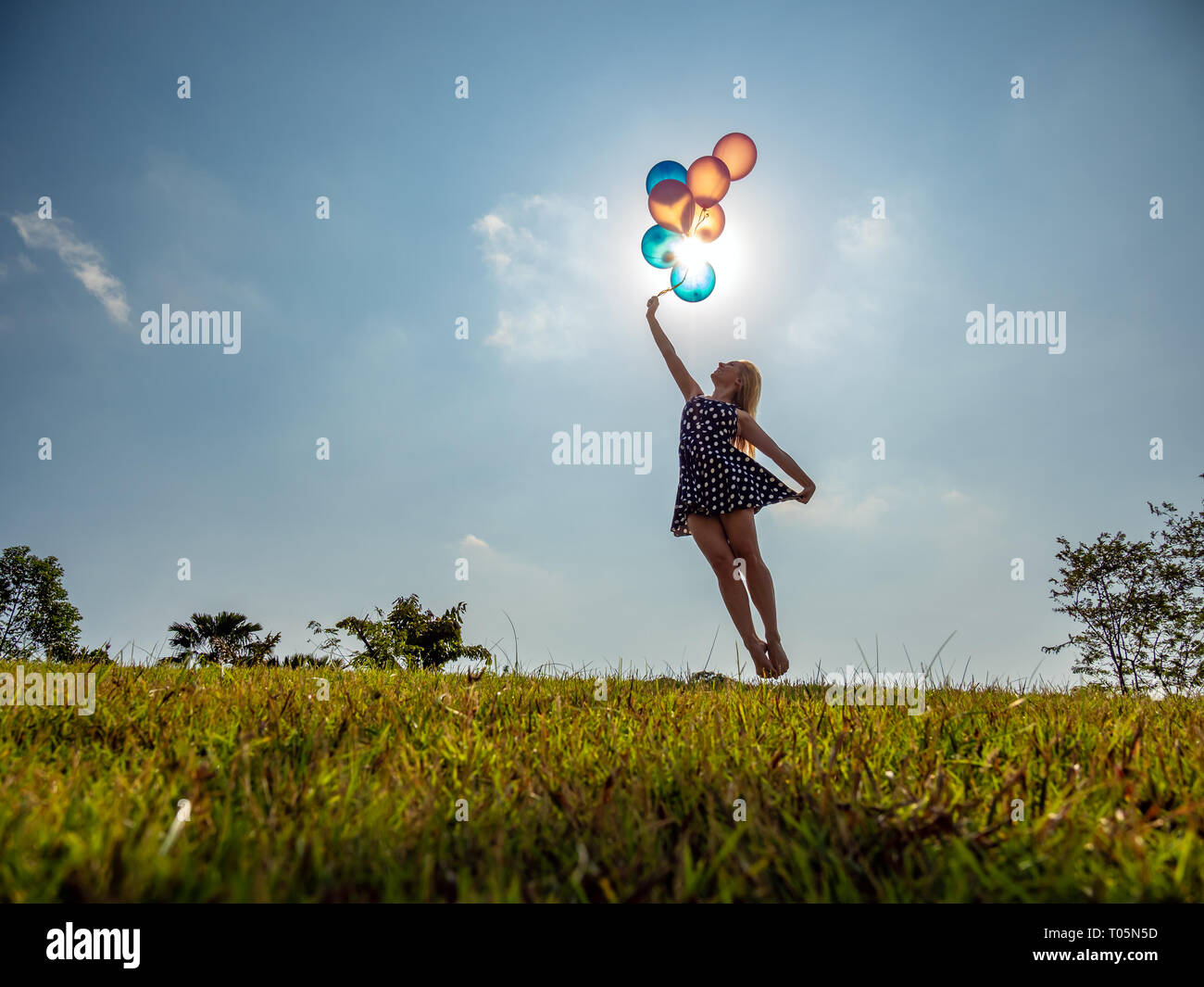 Female ballet dancer holding balloons Stock Photo - Alamy