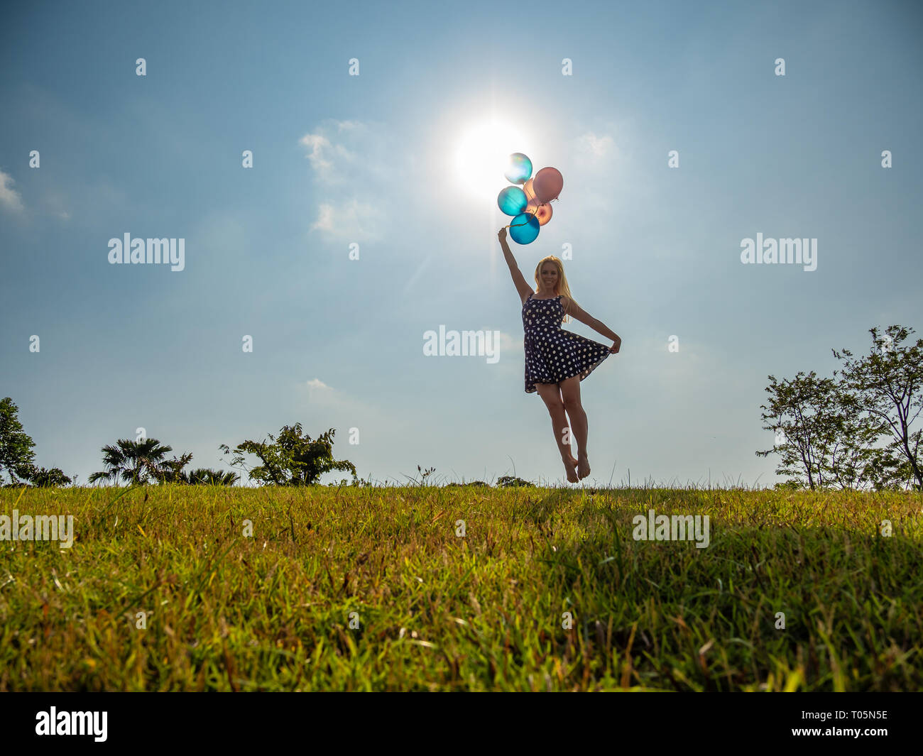 Female ballet dancer holding balloons Stock Photo - Alamy