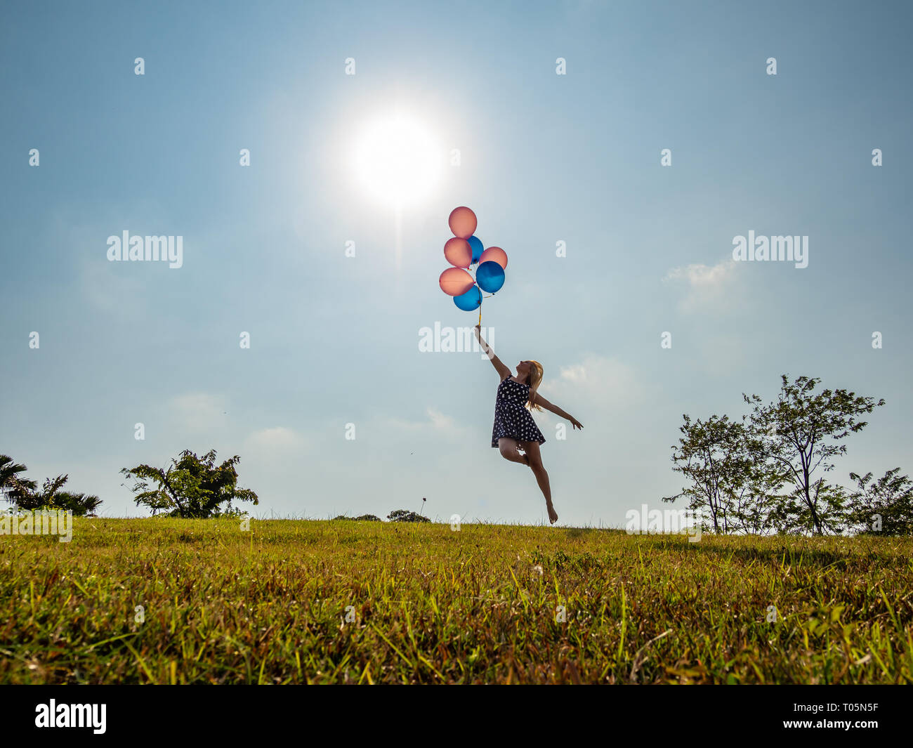 Female ballet dancer holding balloons Stock Photo - Alamy