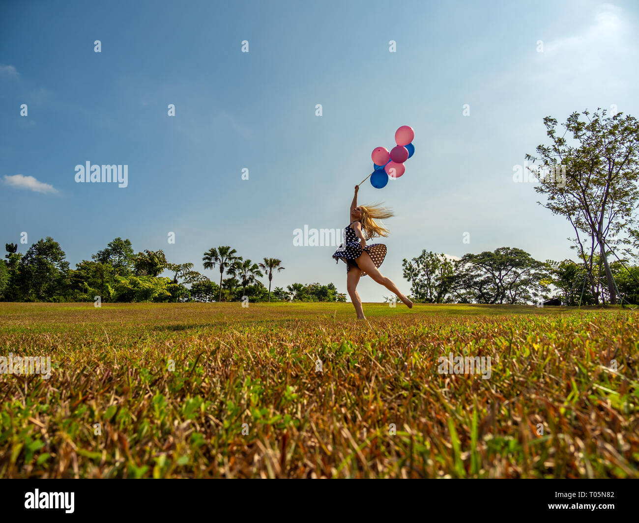 Female ballet dancer holding balloons Stock Photo - Alamy