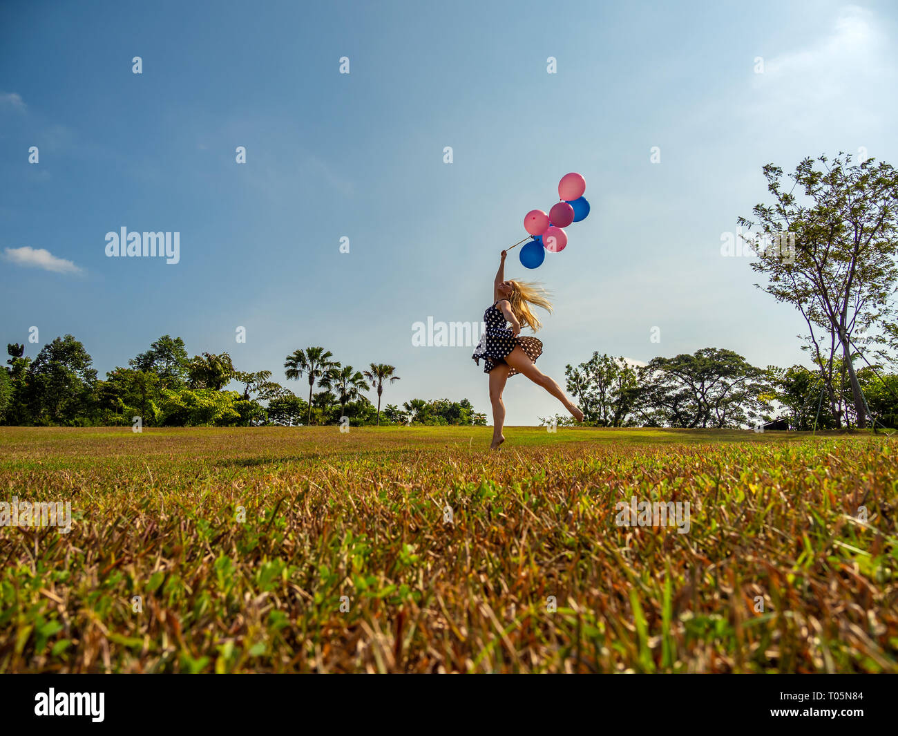 Female ballet dancer holding balloons Stock Photo - Alamy