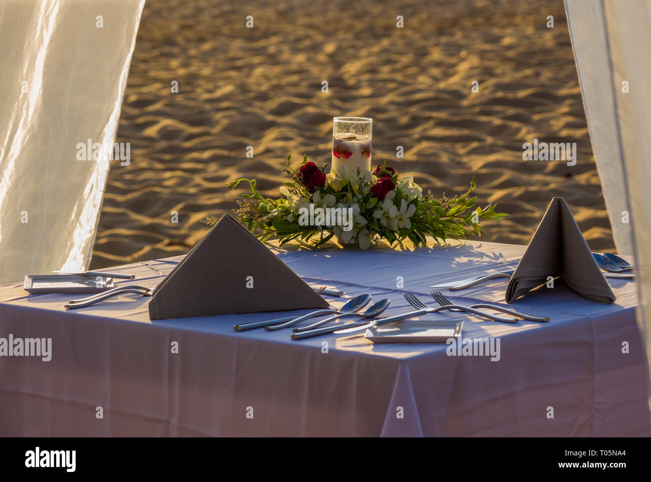 Dinner table for two at the beach at sunset Stock Photo - Alamy