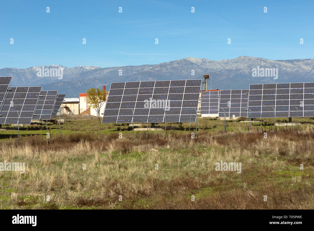 Energy plant with solar panels and a mountain of background Stock Photo ...