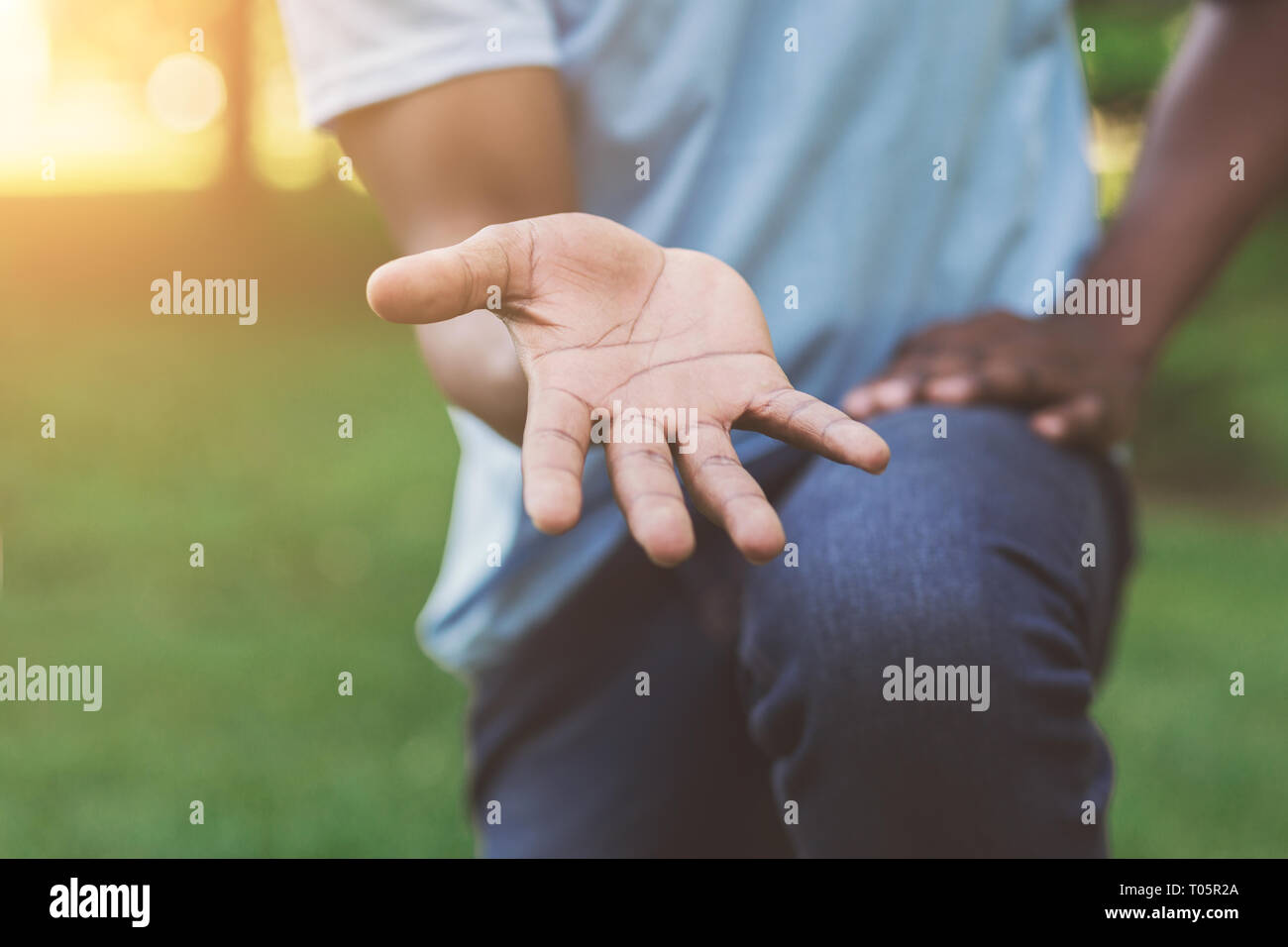 Man offering something in empty hand to camera Stock Photo - Alamy