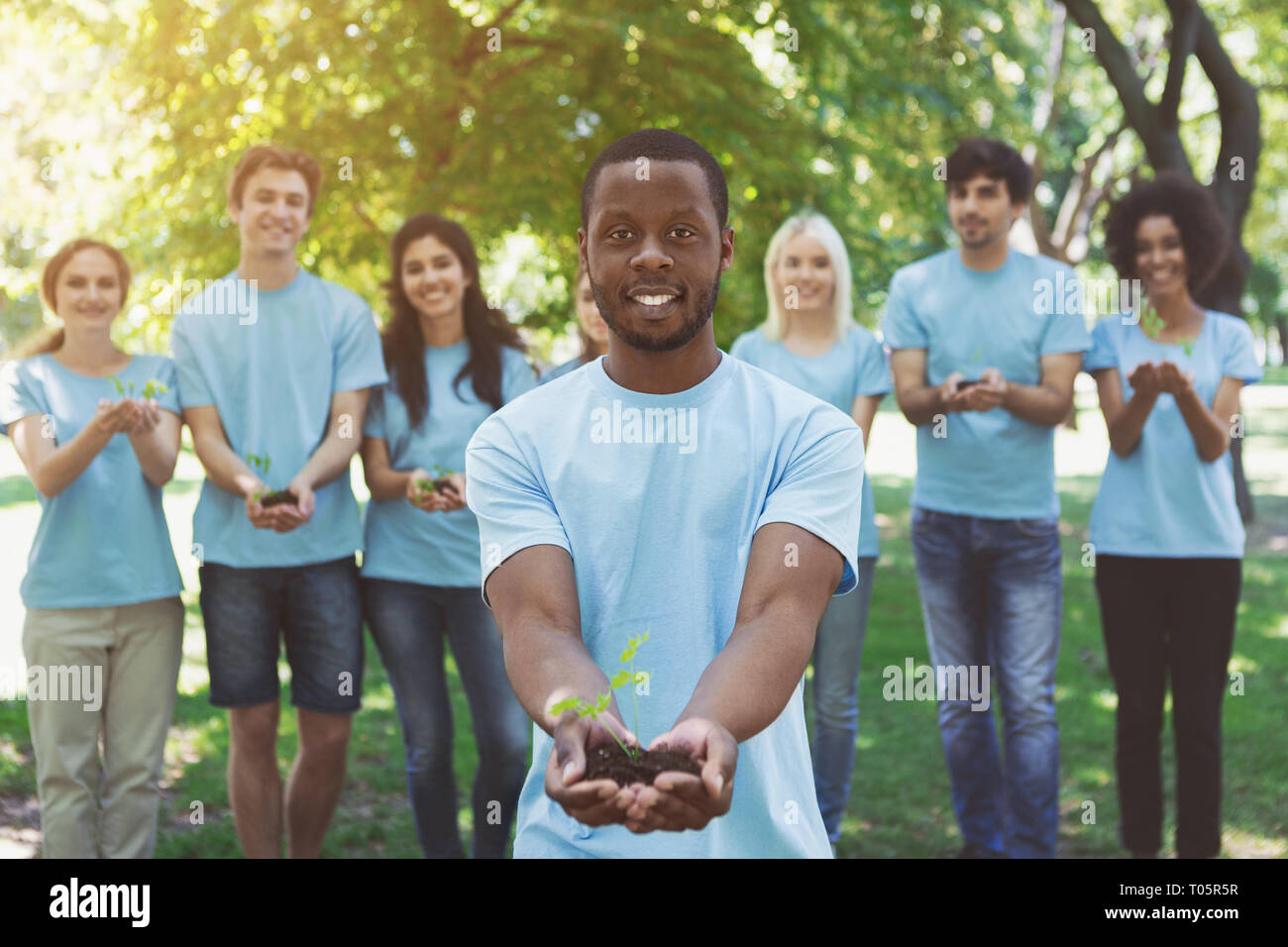 Group of volunteer with trees for growing Stock Photo - Alamy