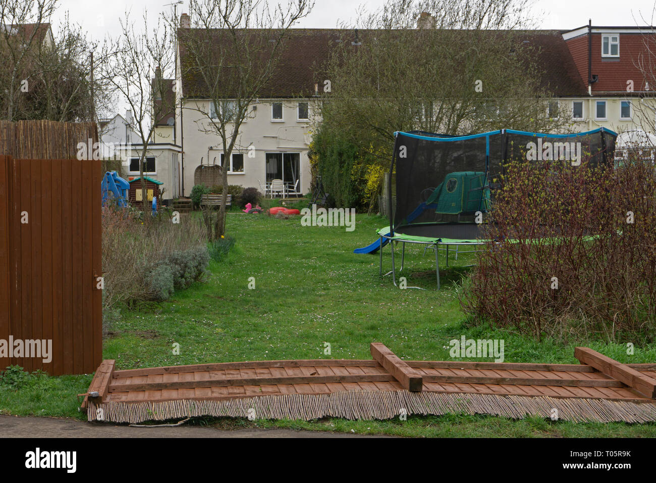 wooden fence blown over by strong wind Stock Photo - Alamy