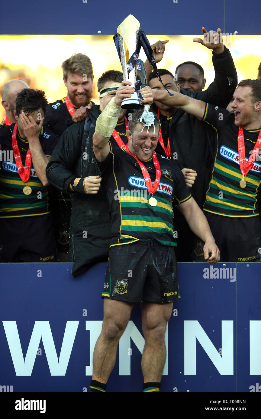 Northampton Saints Alex Waller is soaked with champagne as he lifts the ...