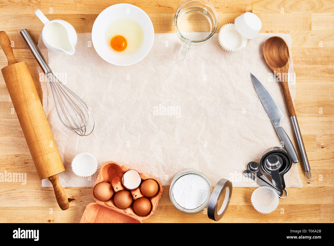 Rolling pin, food ingredients and kitchen utensils on crumpled piece of ...