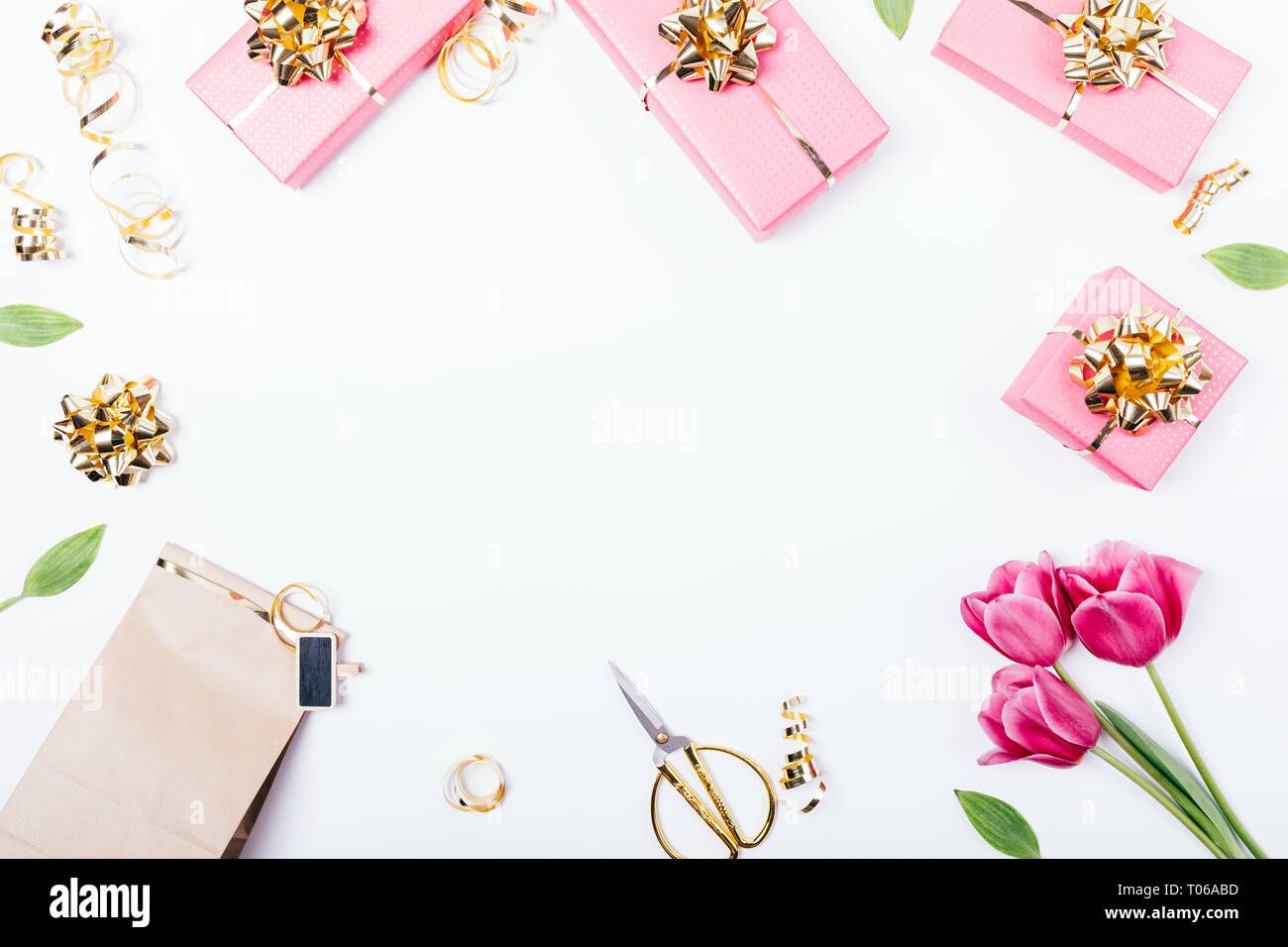 View from above on table with present boxes, bows and ribbons to wrap ...
