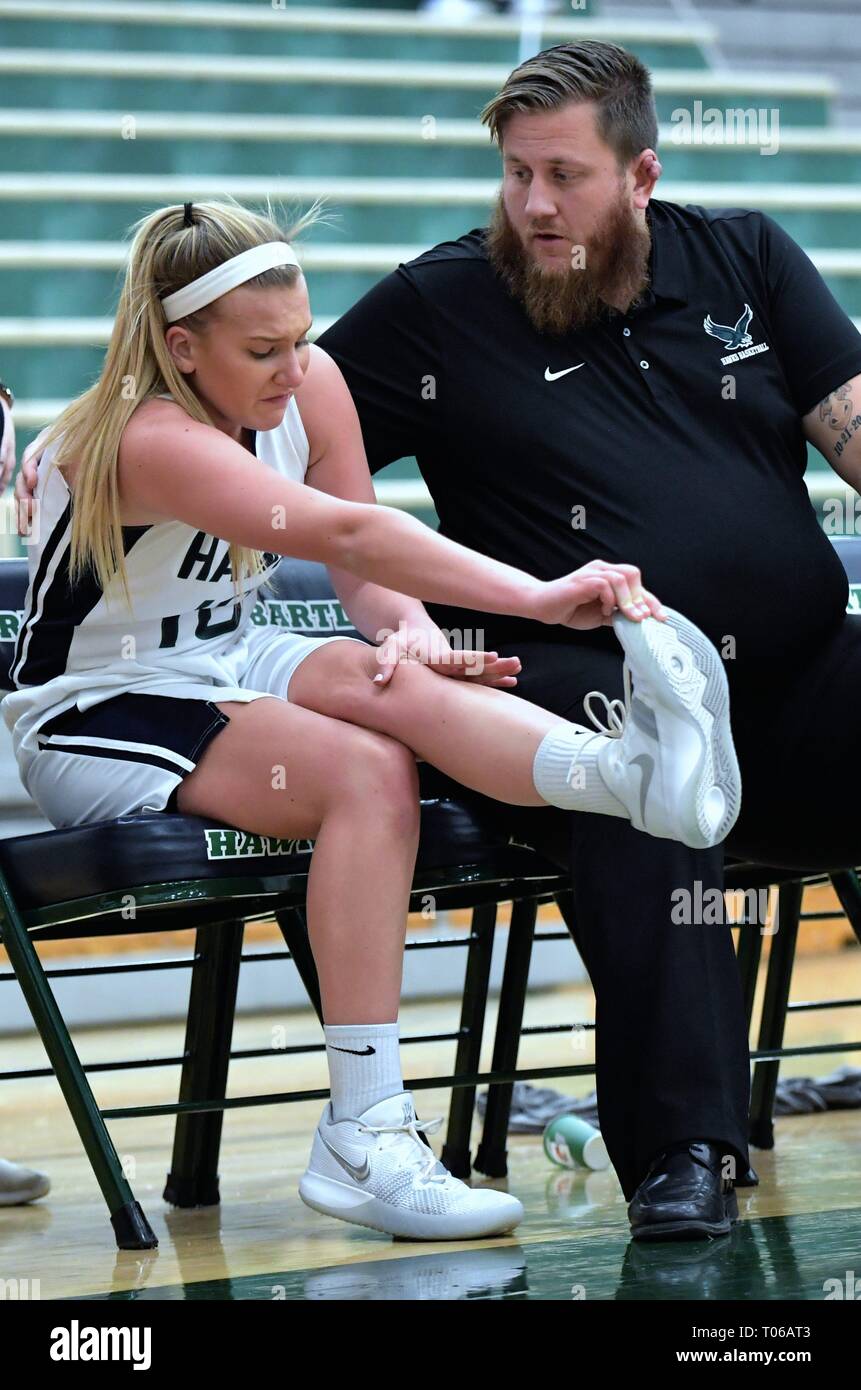 While sitting on the bench, a player stretches out a potential injury ...