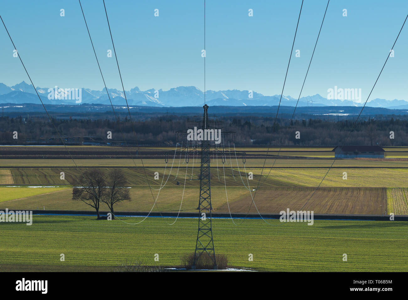 Power line with Alps Stock Photo - Alamy