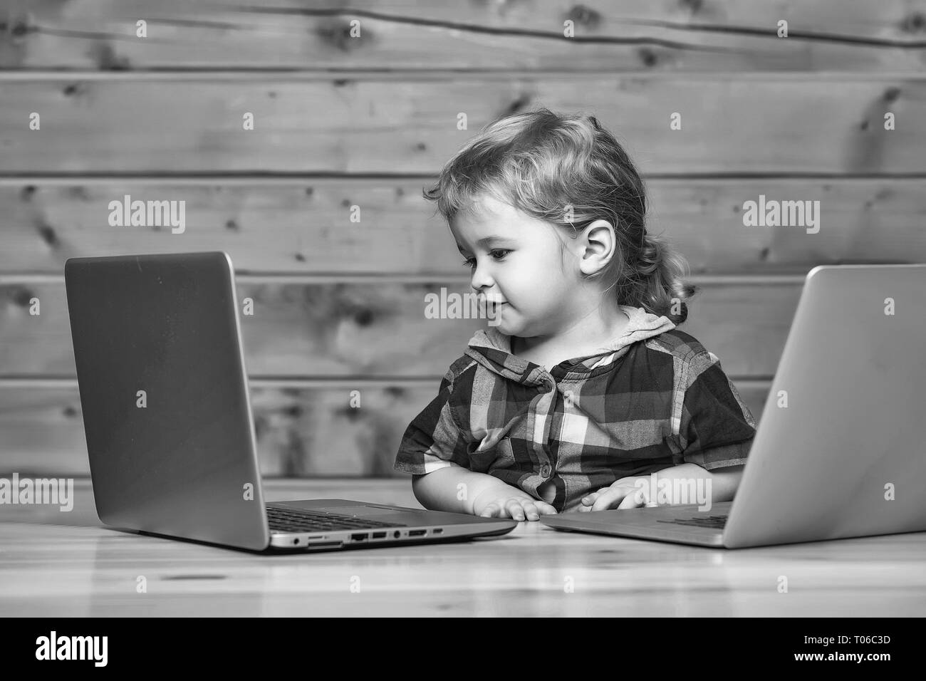 Cute boy plays on computers Stock Photo - Alamy