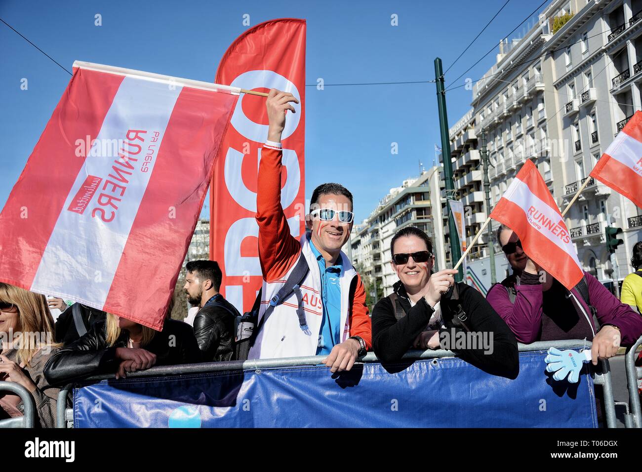 Spectators seen with flags cheering to runners during the Athens Half ...