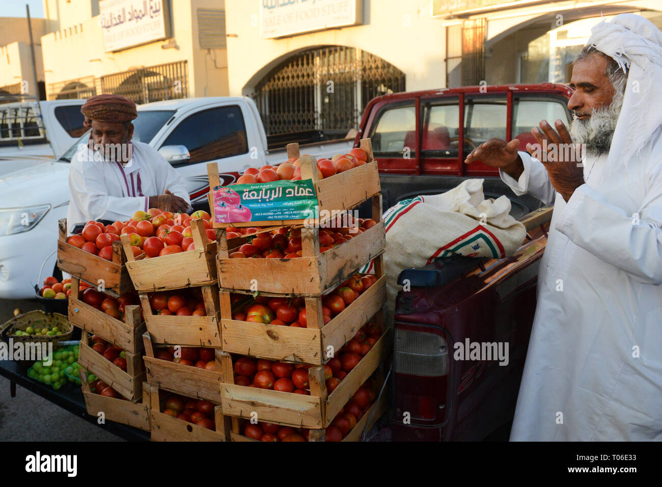 An Omani man selling his tomatoes at the Sinaw cattle market in Oman ...