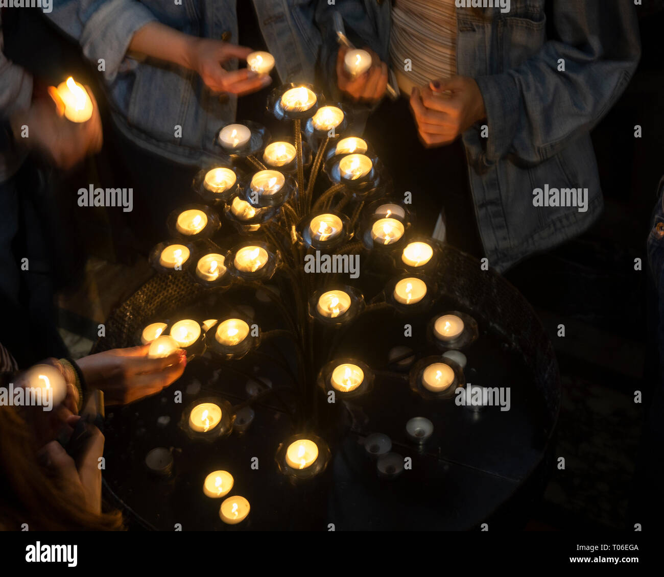 Lighting offertory candles at San Pietro in Vincoli Stock Photo - Alamy