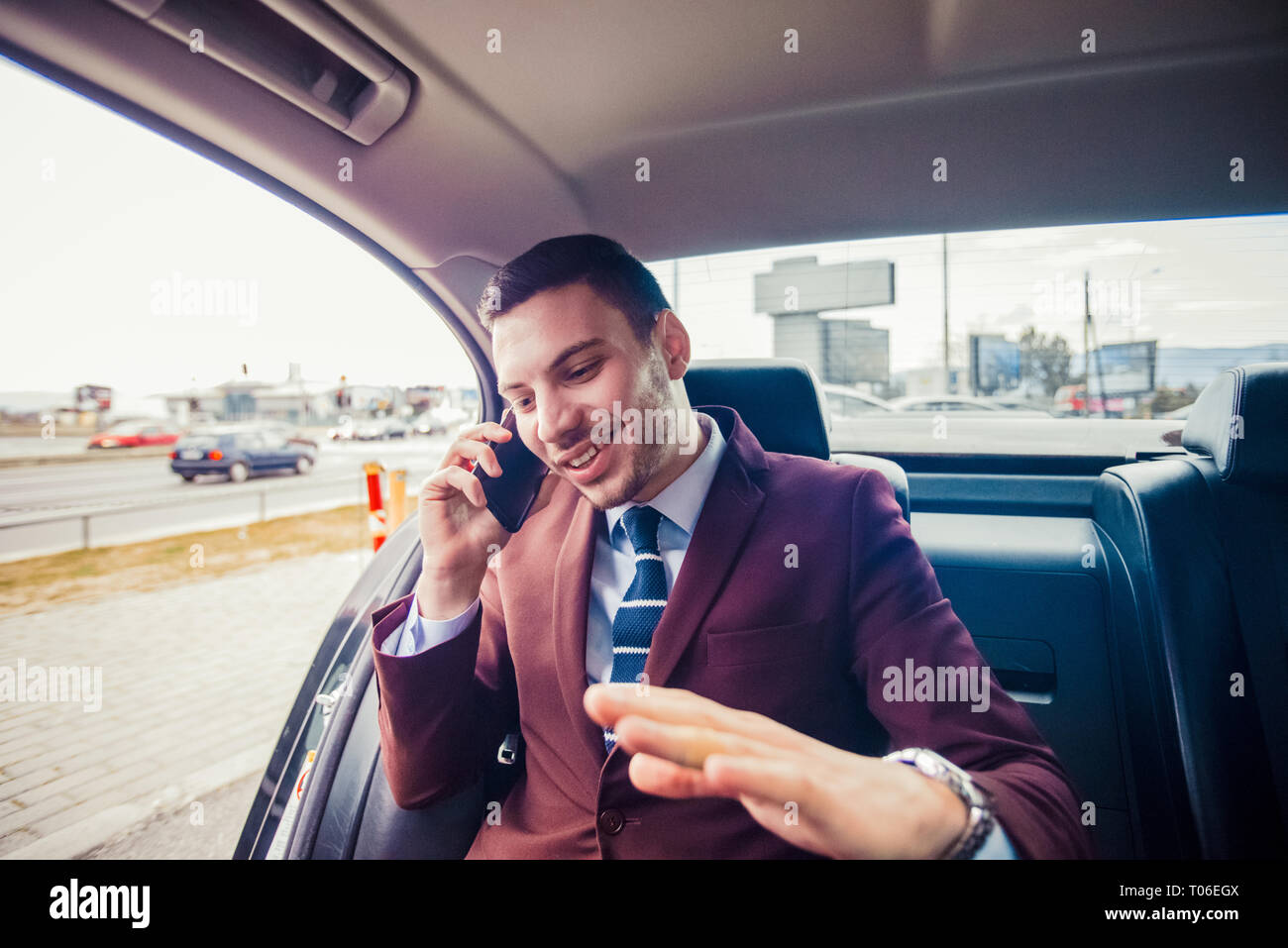 Busy businessman sitting in his limo and talking on mobile phone Stock ...