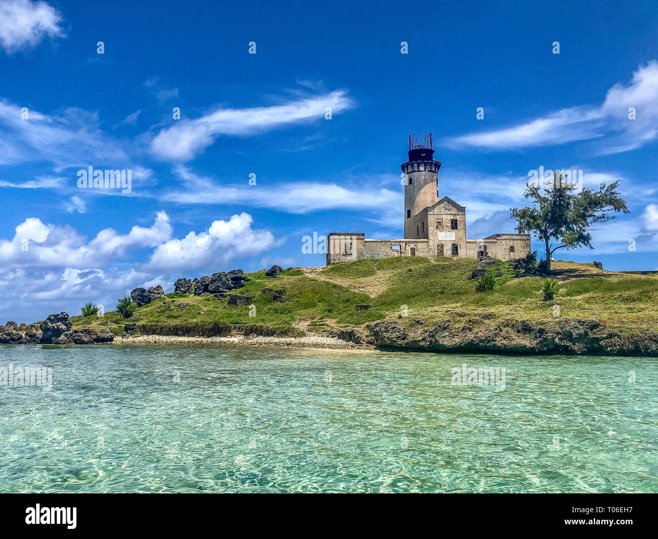 view on small island with lighthouse in blue bay lagoon mauritius ...