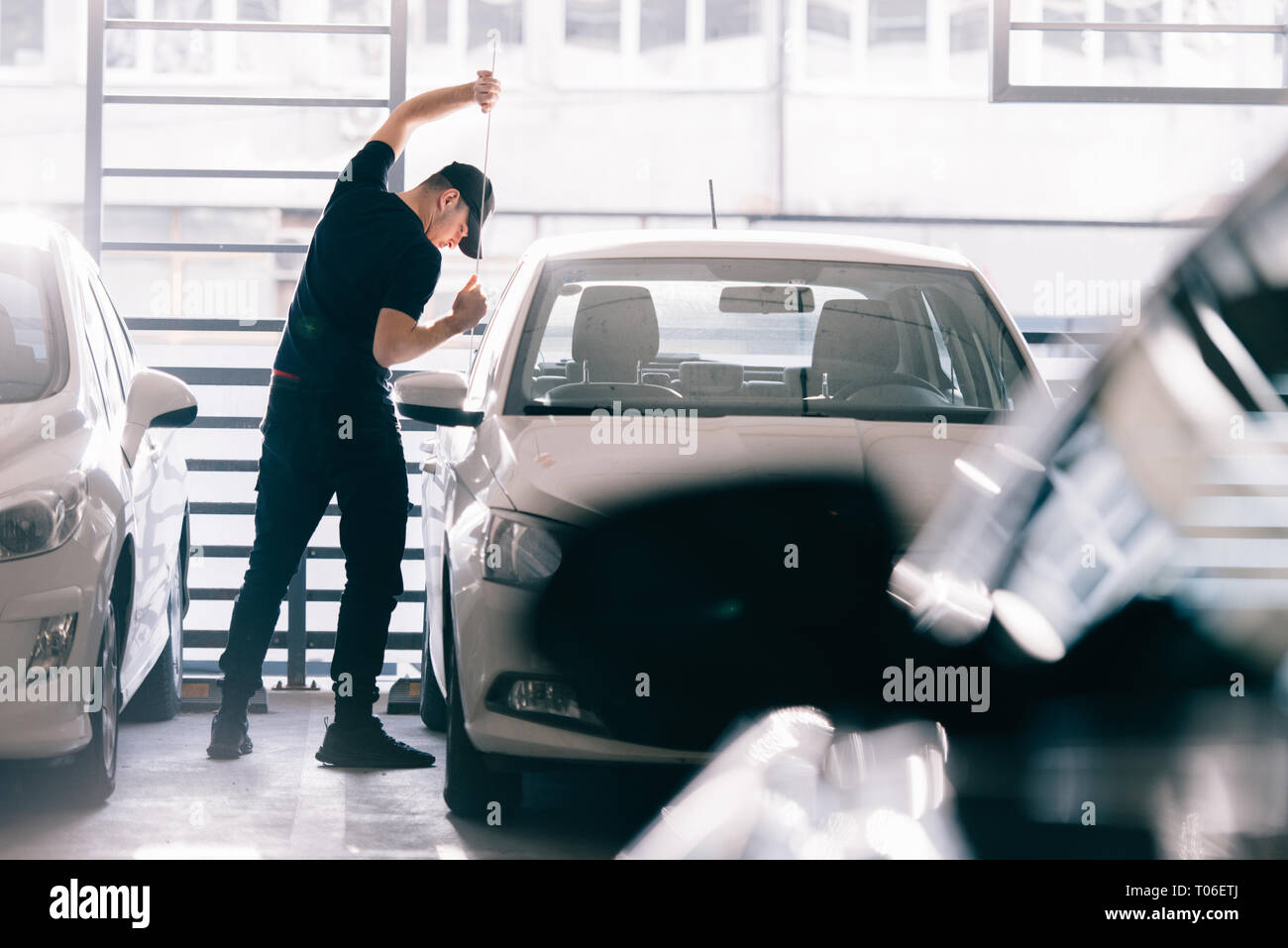 Thief is trying to rob a car with crowbar tool Stock Photo - Alamy