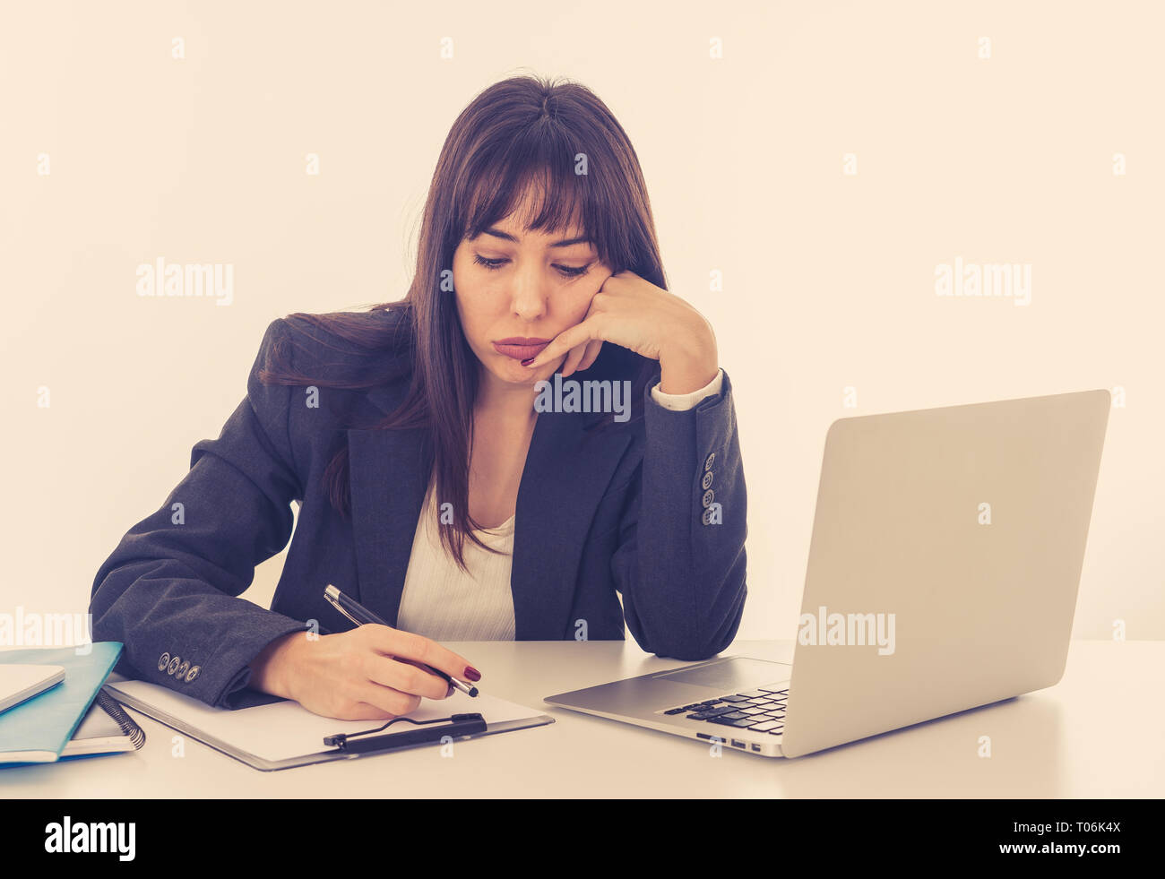 Young beautiful business woman suffering stress working on laptop at ...