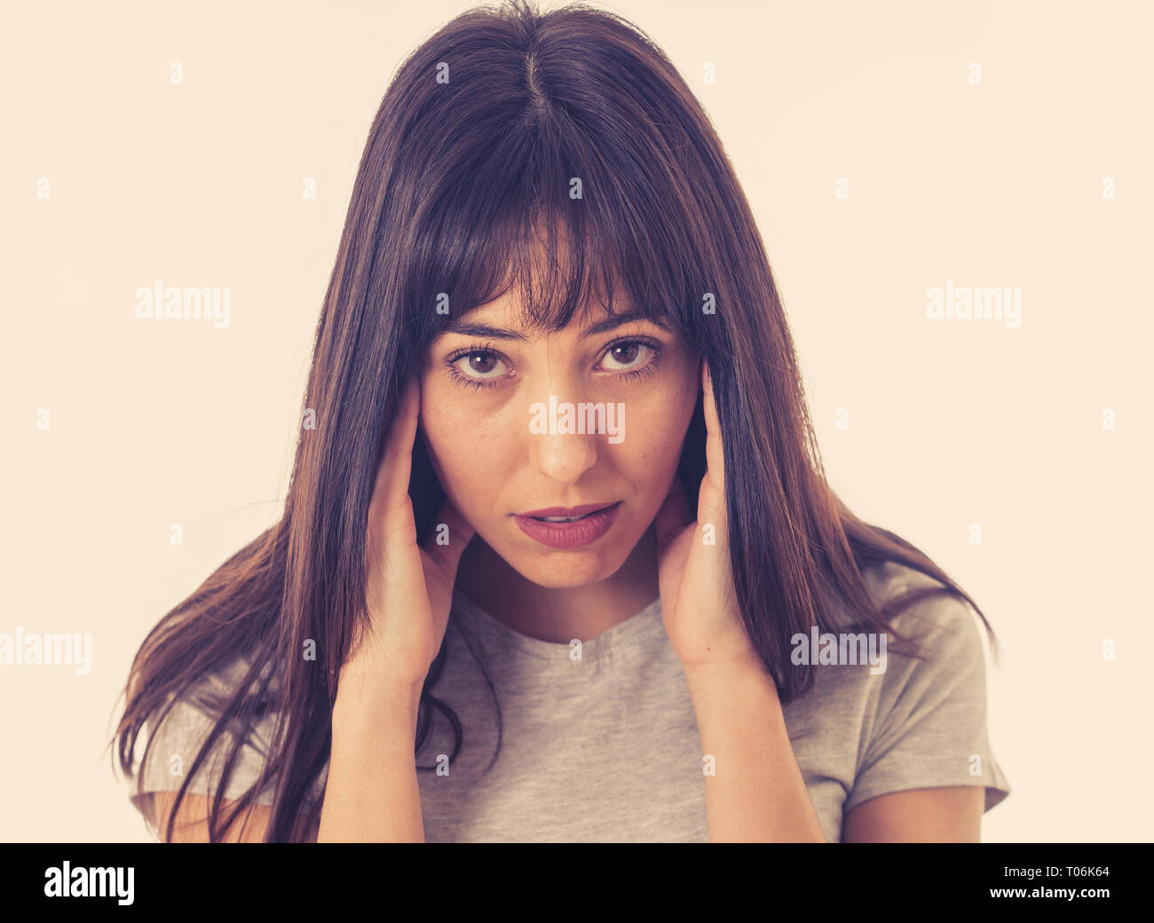 Close up portrait of a young sad woman, serious and concerned, looking ...