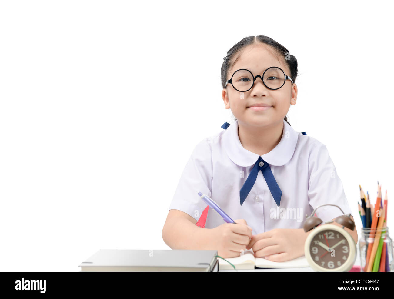 Cute asian student doing homework on table isolated and copy space on ...