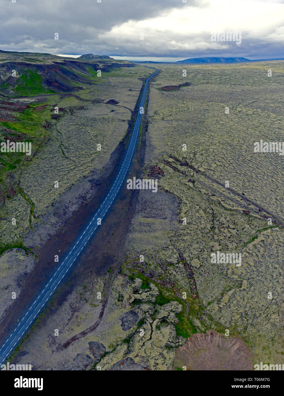 stunning drone shots of an isolated road passes through a volcanic ...