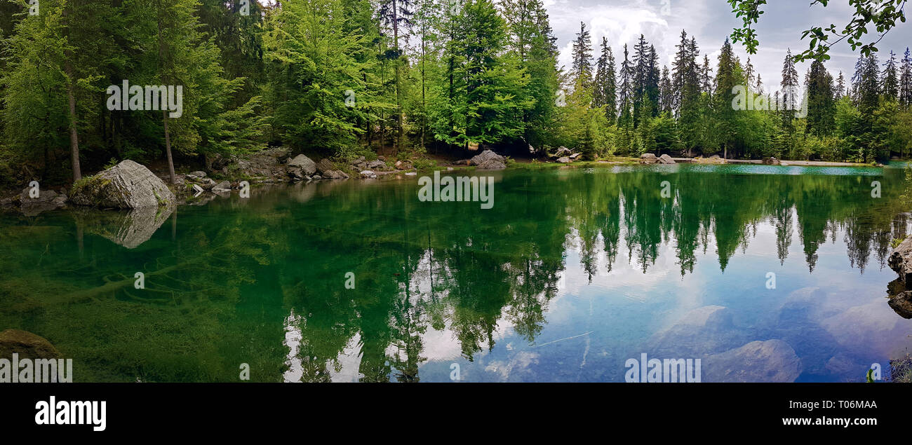 Aerial Drone shots above an alpine lake. The Crystal alpine waters are ...