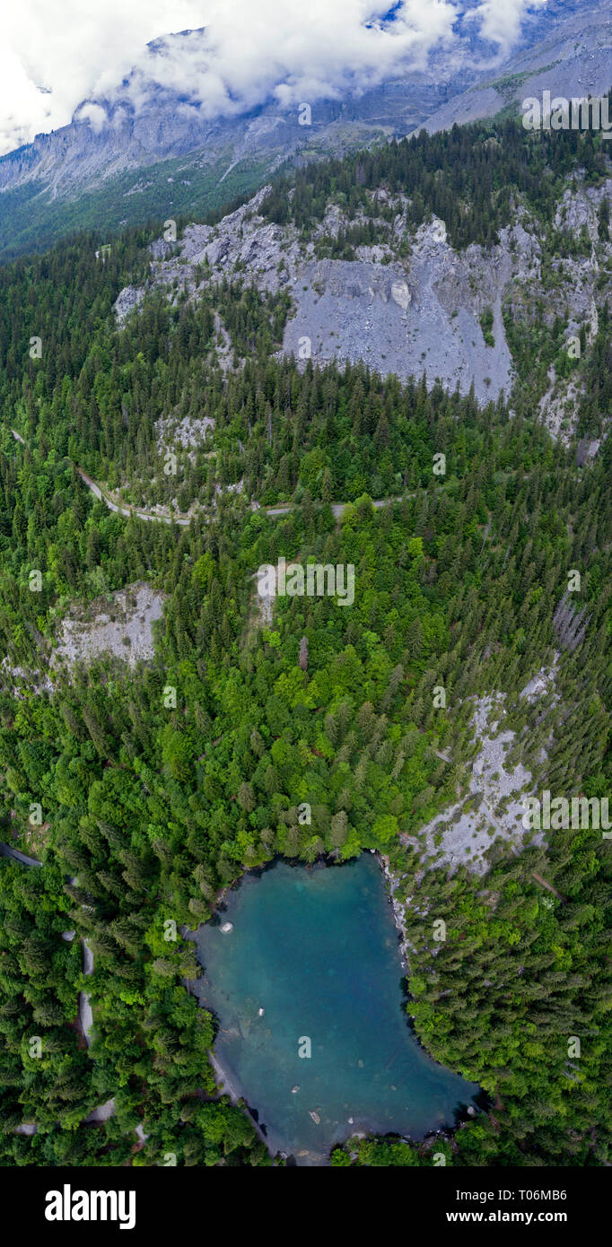 Stunning drones shots of an alpine valley with high mountains and lush ...