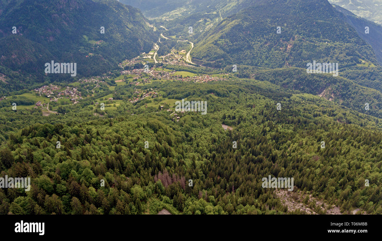 Stunning drones shots of an alpine valley with high mountains and lush ...
