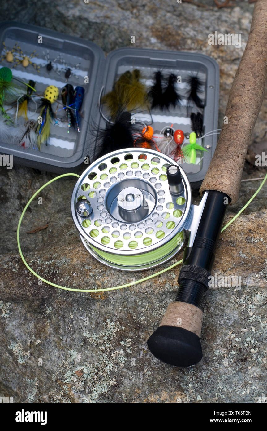 Beautiful Fly Fishing Reel with Flies in a Tackle Box on a Rock Stock ...